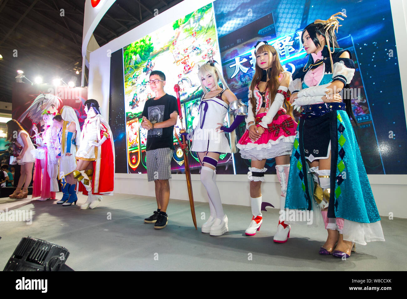 Showgirls dressed in cosplay costumes pose during the 11th China ...