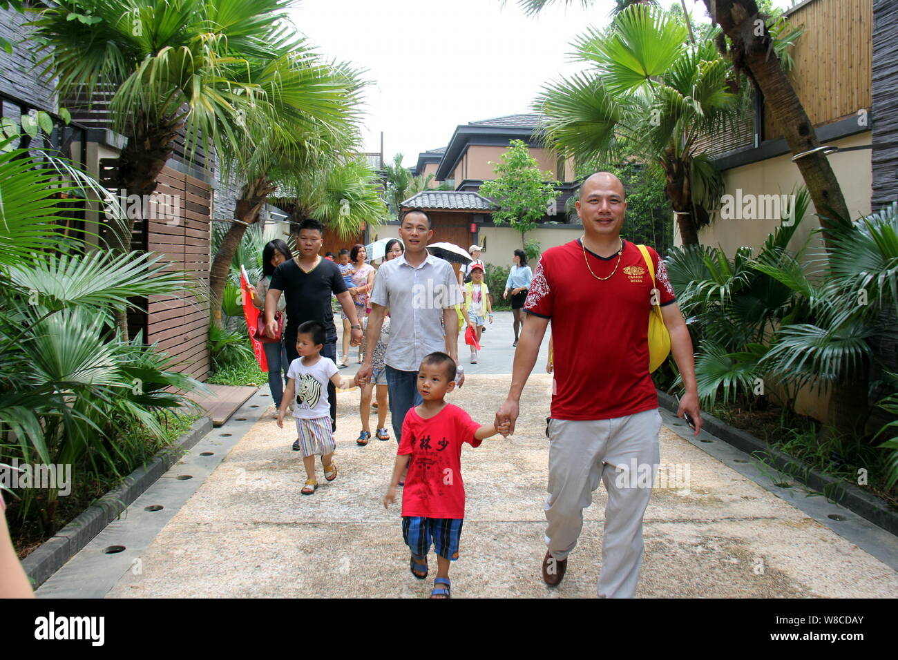 Chinese parents and their children visit a luxury villa during a tour ...
