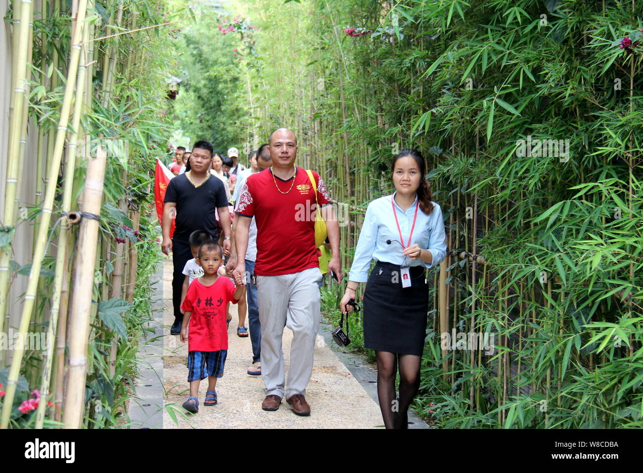 Chinese parents and their children visit a luxury villa during a tour ...