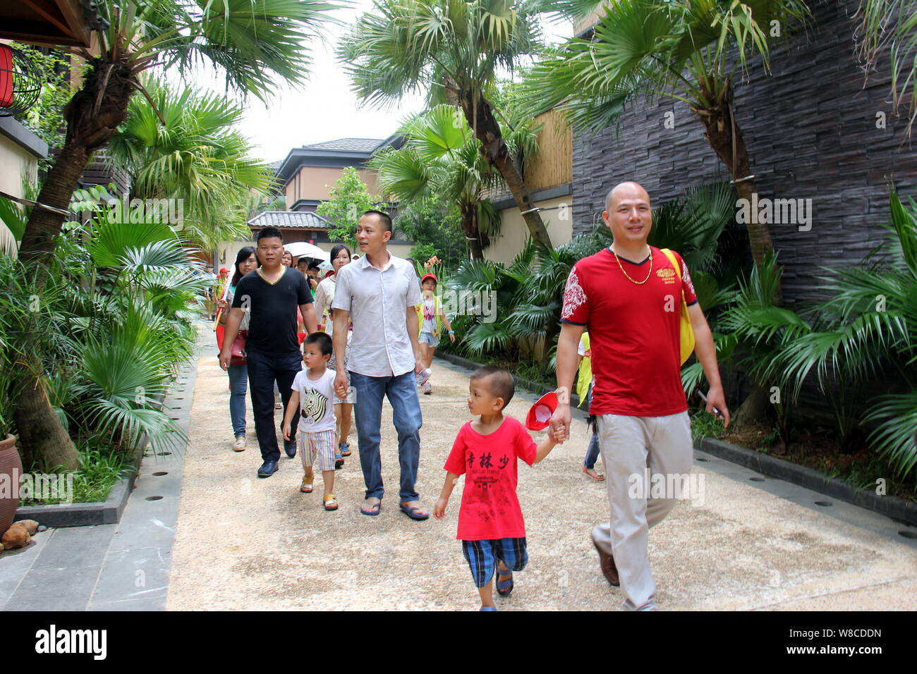Chinese parents and their children visit a luxury villa during a tour ...