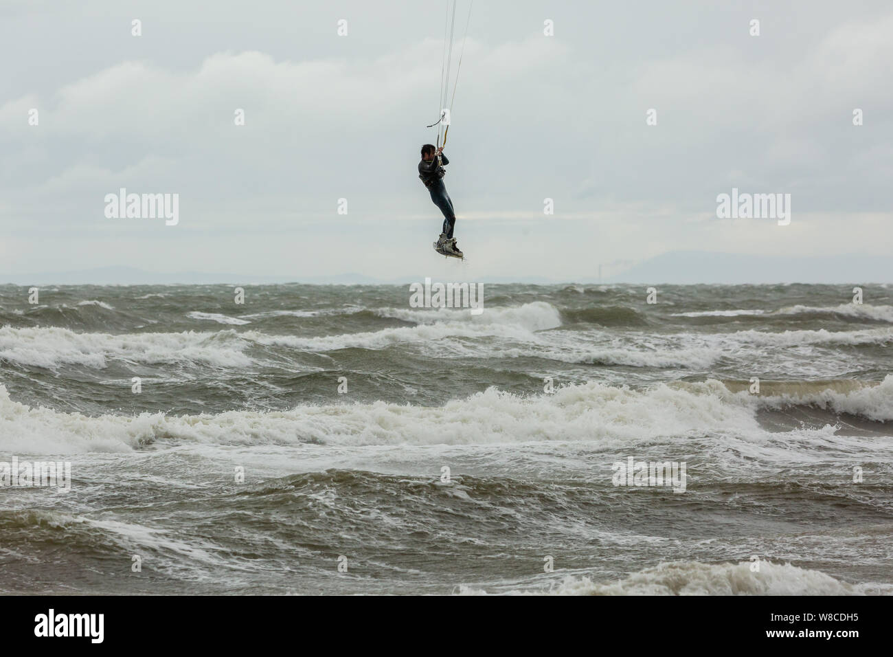 Melbourne, Australia. 9th August, 2019. A lone Kite Surfer braces the ...