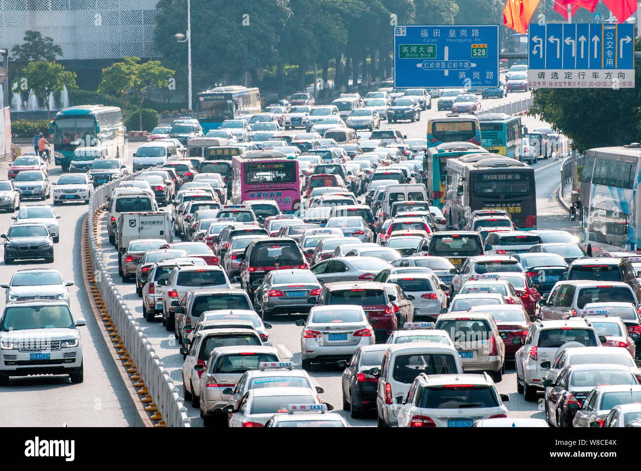 Masses of vehicles move slowly during a traffic jam on a road before ...