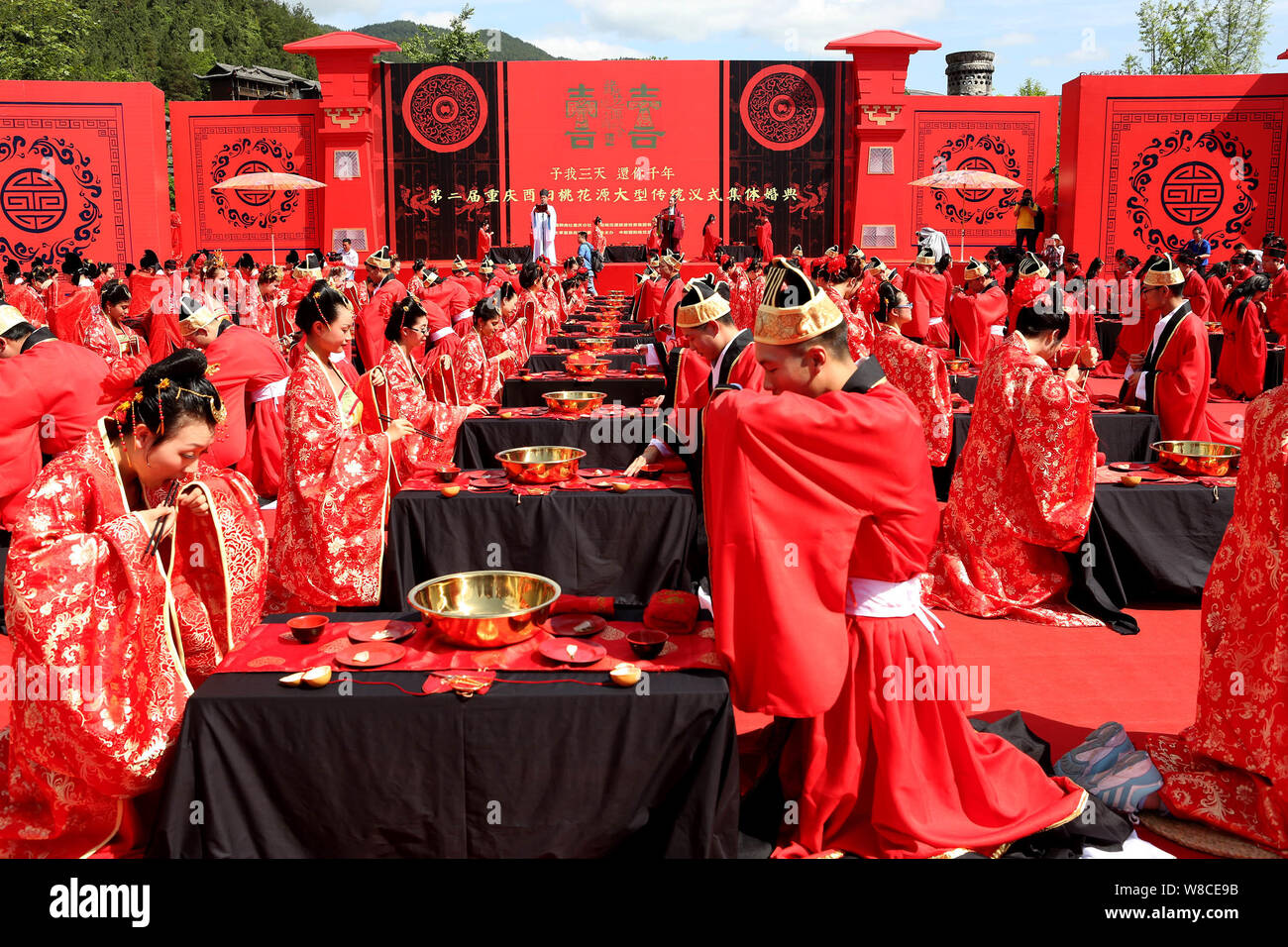 Couples of newlyweds dressed in Chinese Han costumes take part in a Han ...