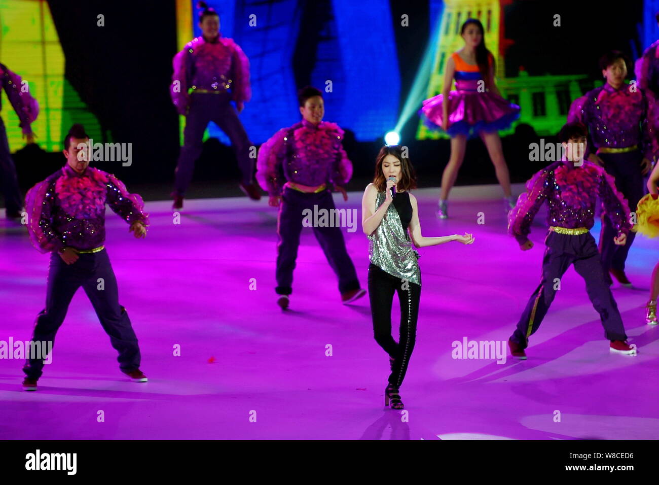 Hong Kong singer and actress Kelly Chen, front, performs at the opening ...