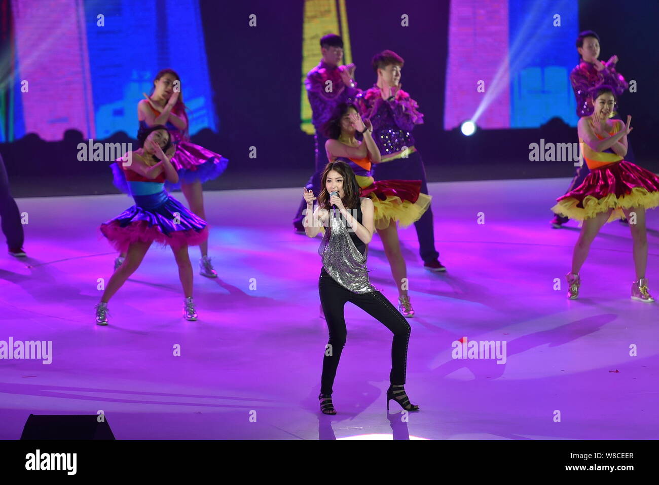 Hong Kong singer and actress Kelly Chen, front, performs at the opening ...