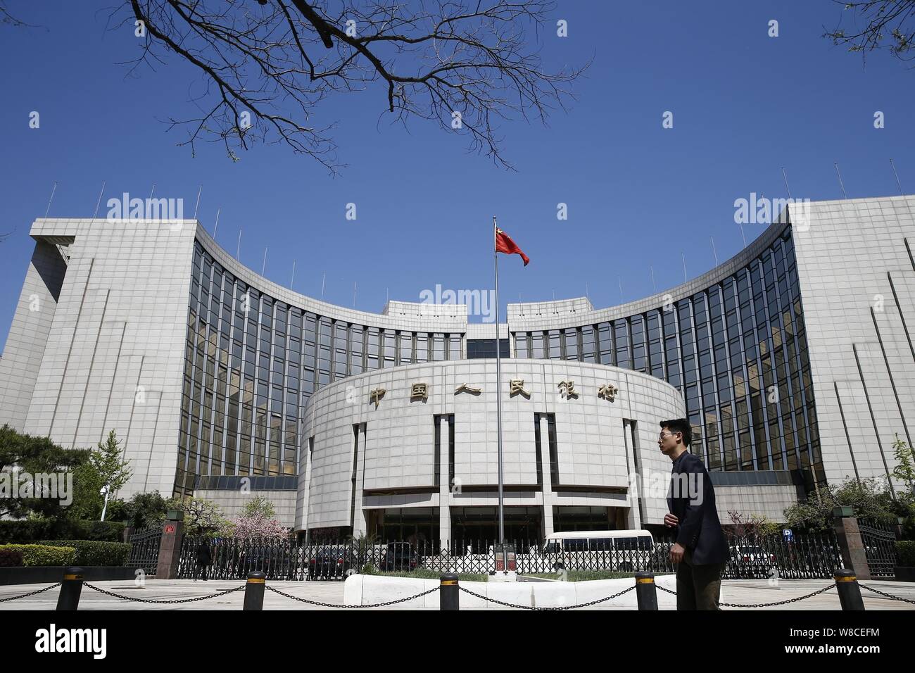 --FILE--A pedestrian walks past the headquarters and head office of the ...