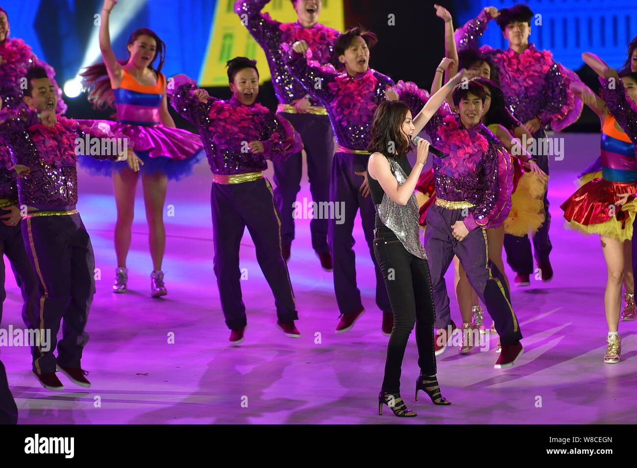 Hong Kong singer and actress Kelly Chen, front, performs at the opening ...