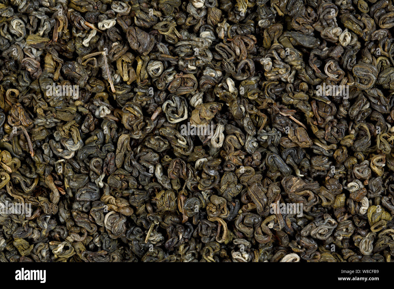 Green tea background. Organic dried green tea leaves Stock Photo - Alamy