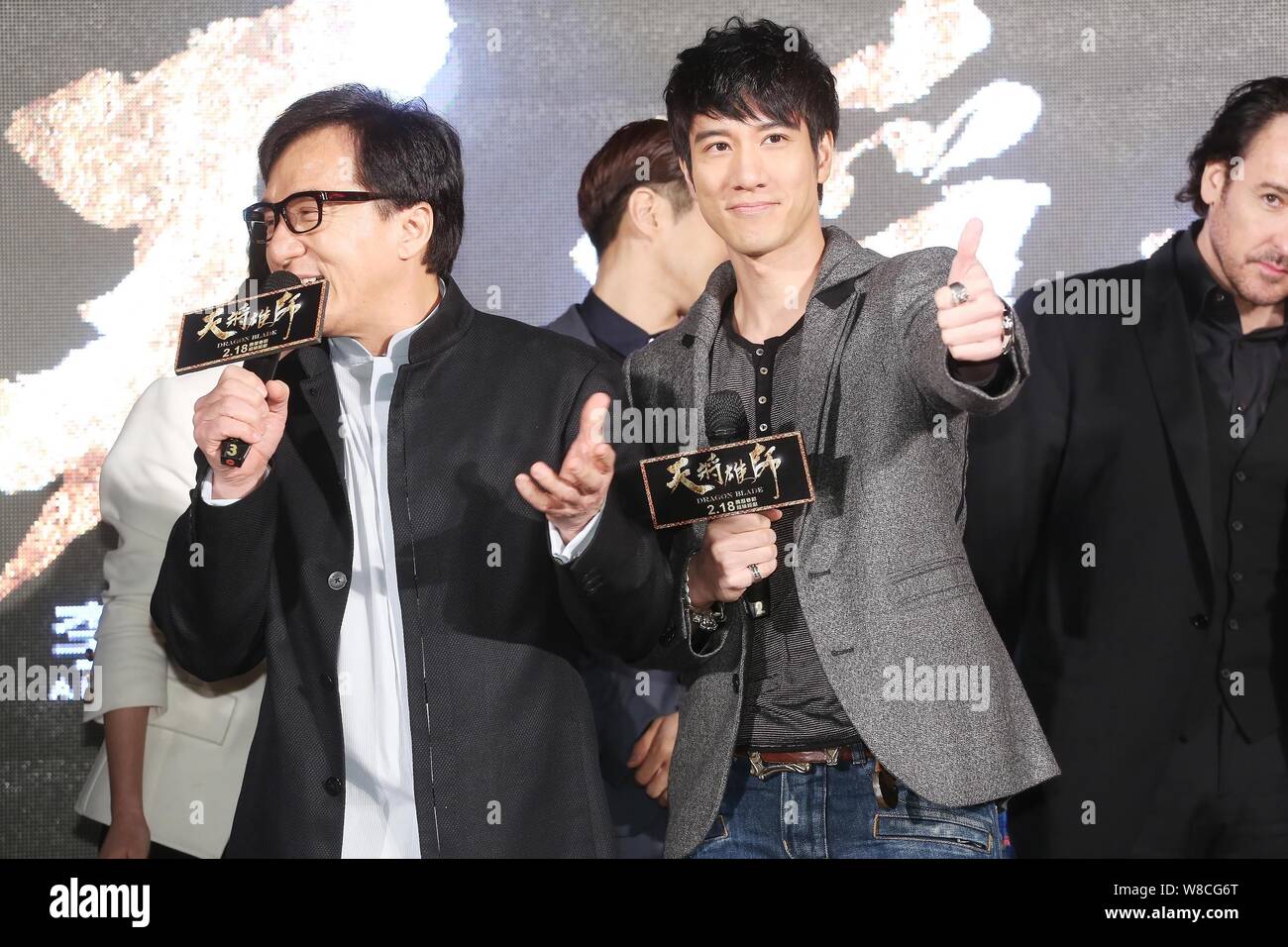 Hong Kong kungfu star Jackie Chan, left, speaks as Taiwan-based ...
