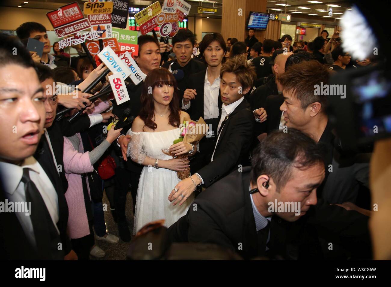 Japanese singer Ayumi Hamasaki, center, is surrounded by reporters at the Taipei Songshan ...