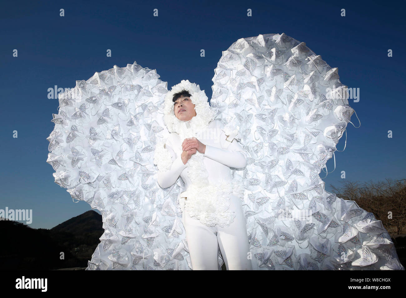Chinese artist Kong Ning, right, dressed in a butterfly costume made ...