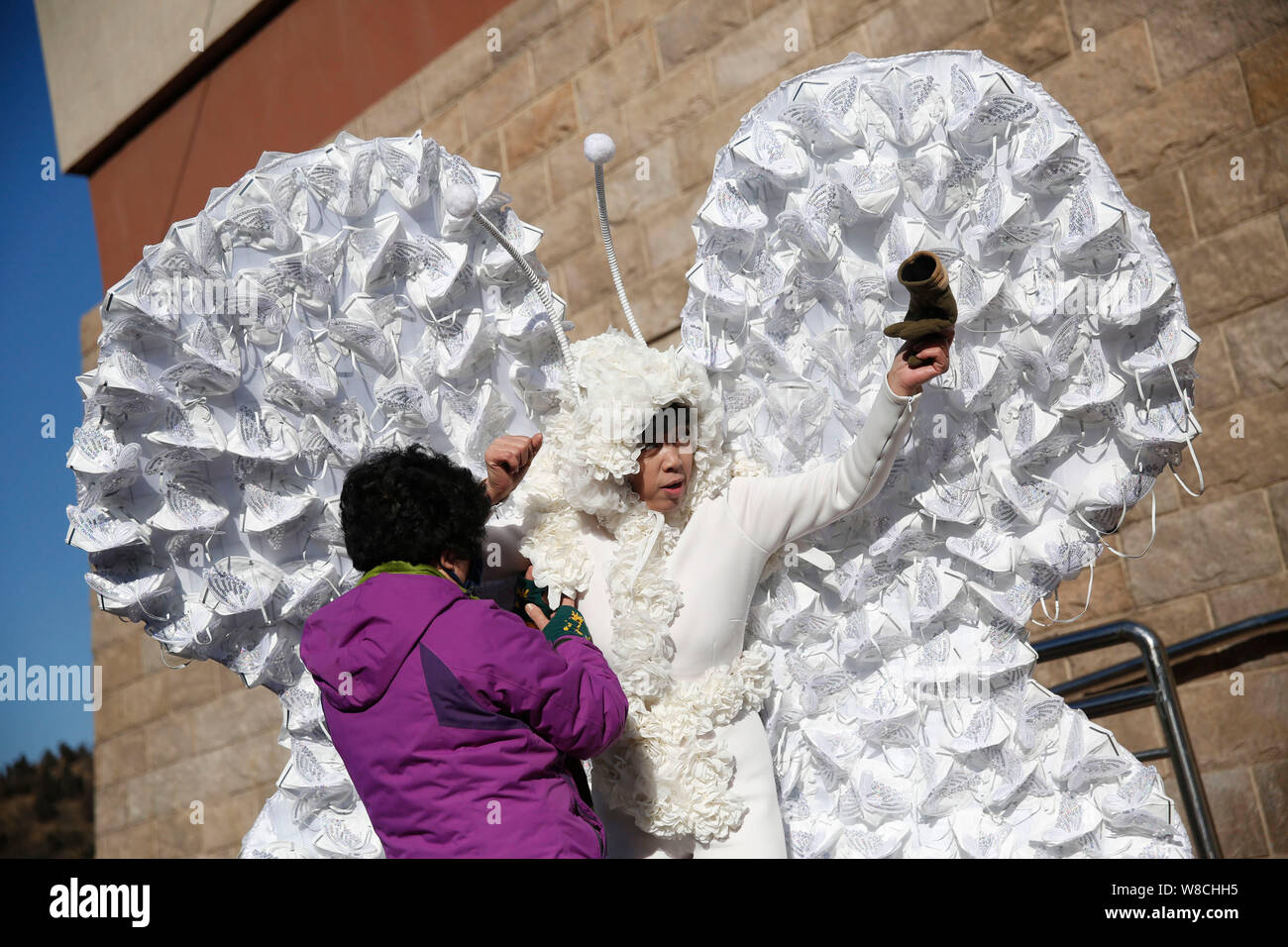 Chinese artist Kong Ning, right, dressed in a butterfly costume made ...