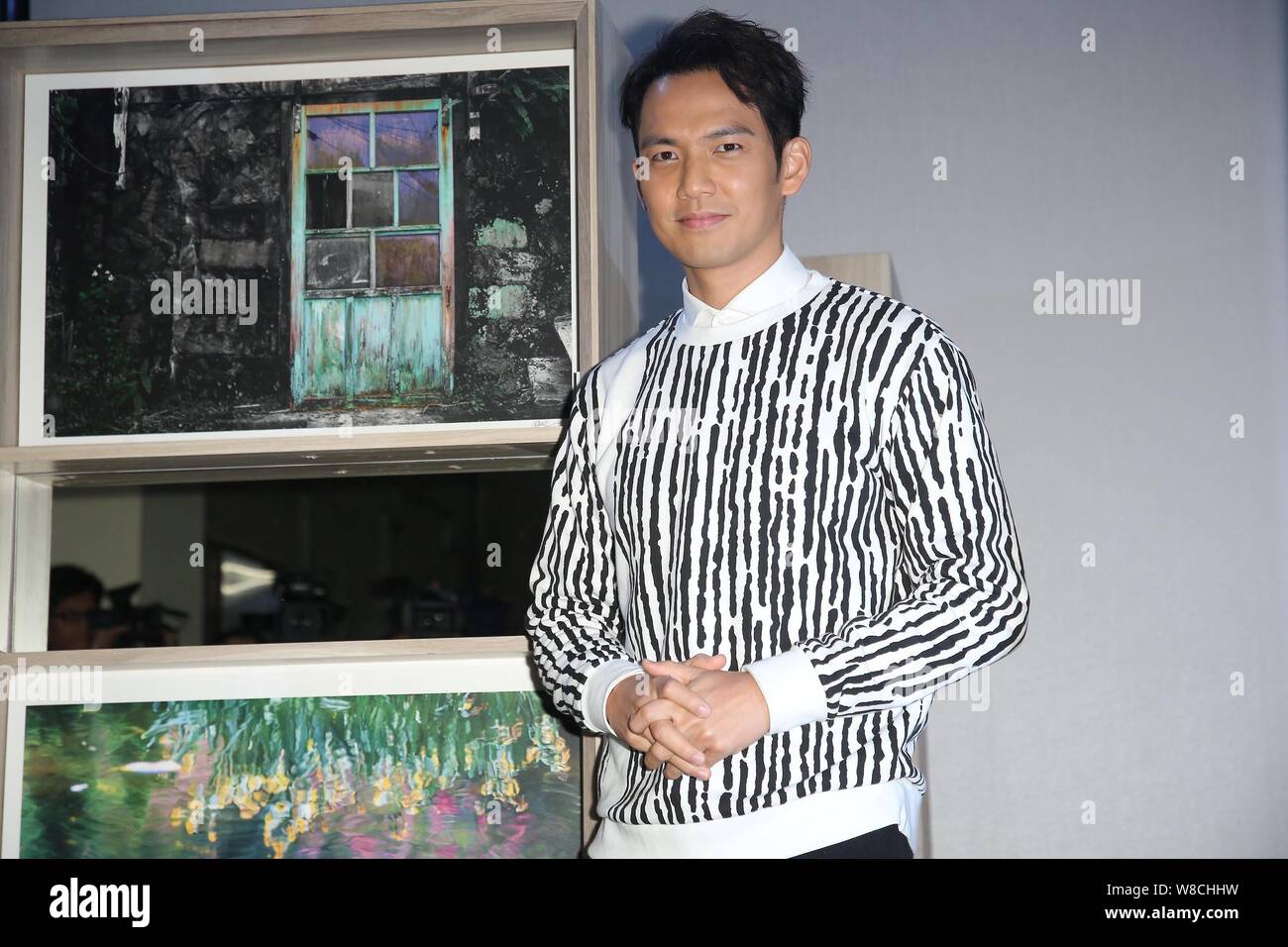 Hong Kong actor Wallace Chung poses during his photo exhibition in ...