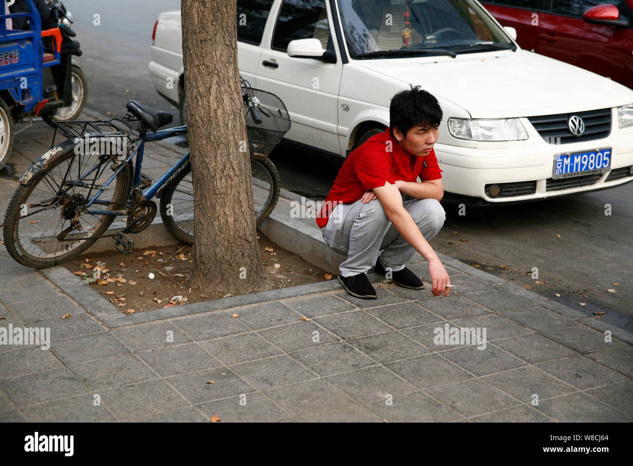 Chinese man smoking cigarette hi-res stock photography and images - Alamy