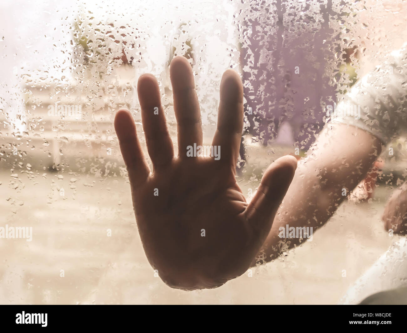 Human Hand pressed against a window with Drops Of Rain on it. Hand ...