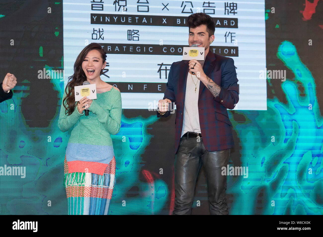 American singer Adam Lambert, right, speaks as Chinese singer Zhang ...