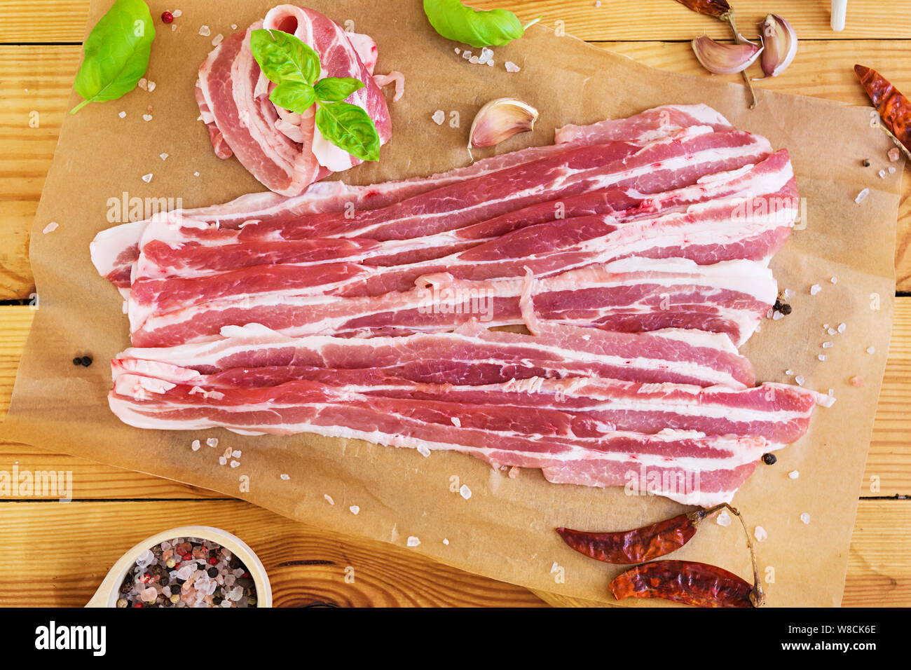Fresh sliced bacon with spices on white background Stock Photo - Alamy
