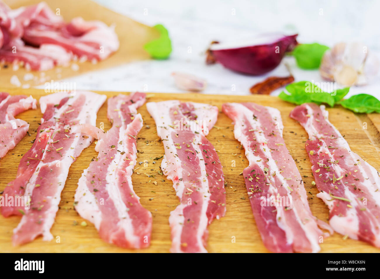 Fresh sliced bacon with spices on white background Stock Photo - Alamy