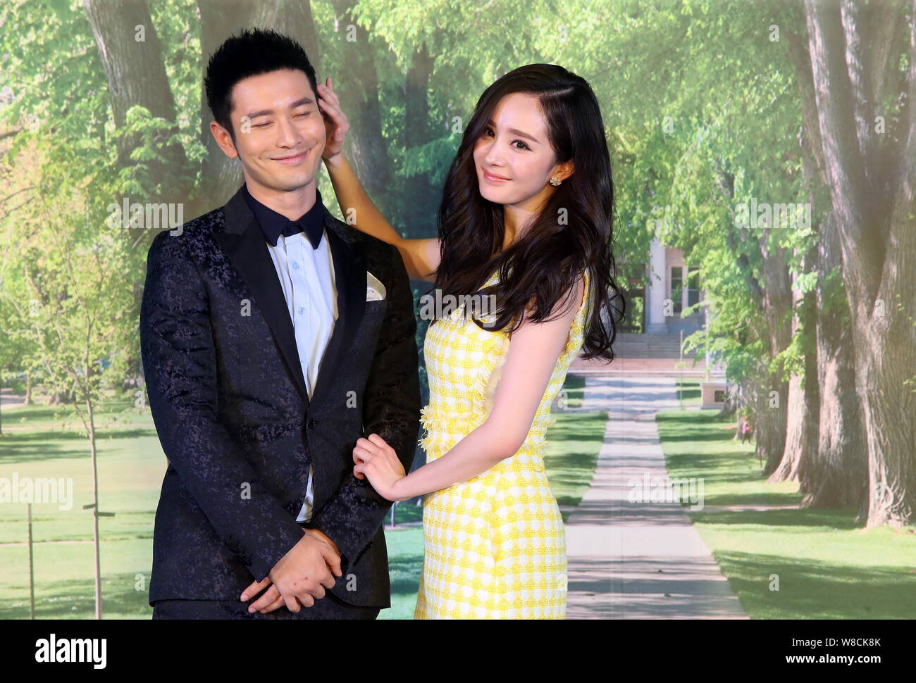 Chinese actress Yang Mi, right, and actor Huang Xiaoming smile during a ...