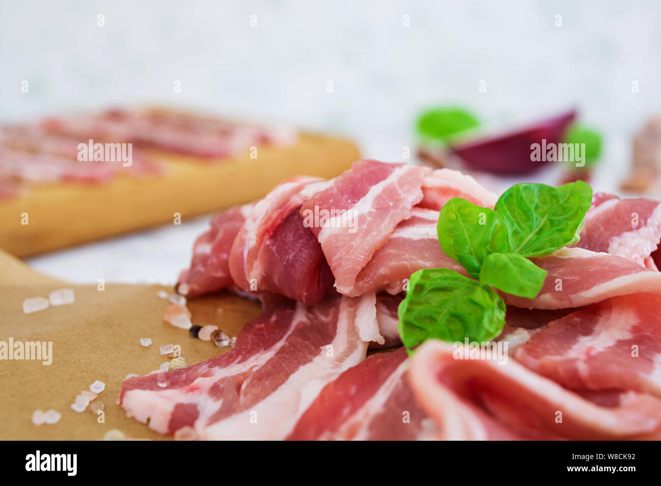 Fresh sliced bacon with spices on white background Stock Photo - Alamy