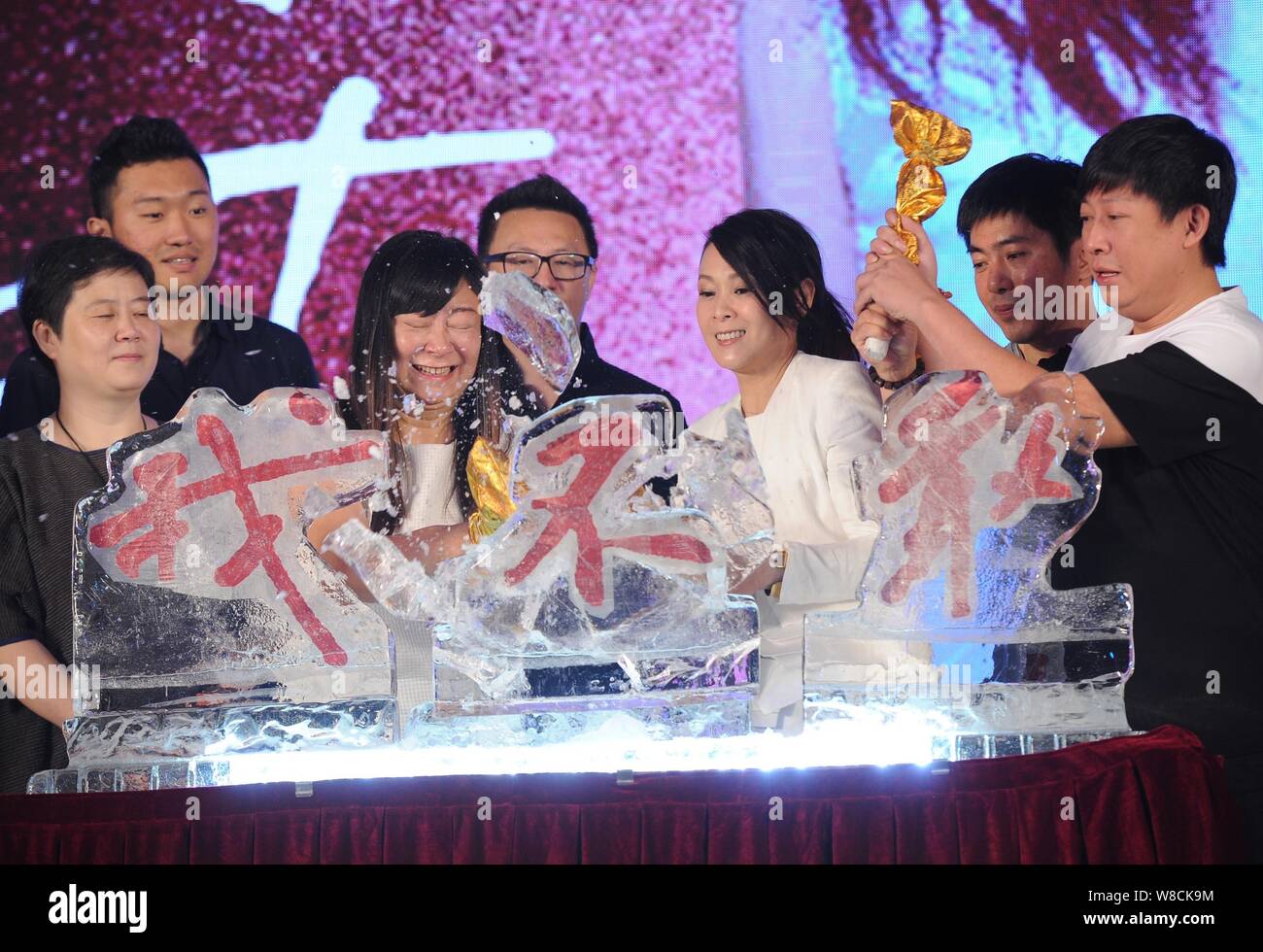 Taiwanese singer and actress Rene Liu, third right, and guests smash an ...