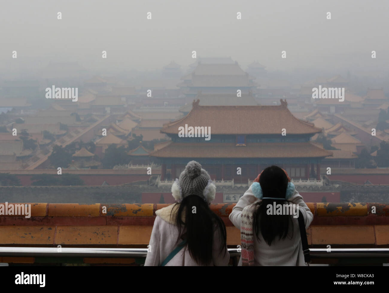 Tourists take photos of the Forbidden City from Jingshan Park in heavy ...