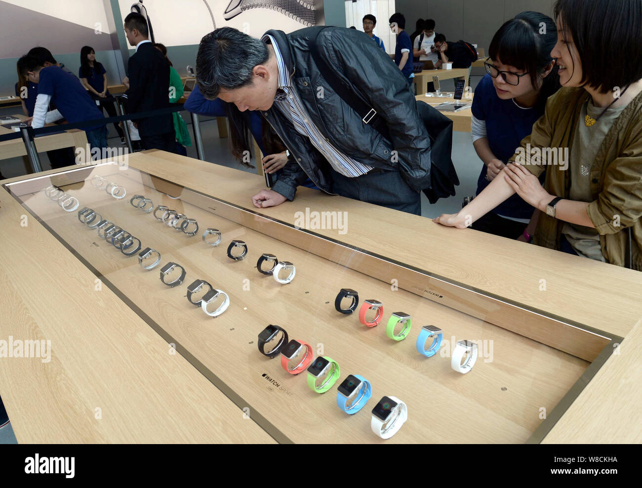 --FILE--Customers look at Apple Watch smart watches at an Apple store ...