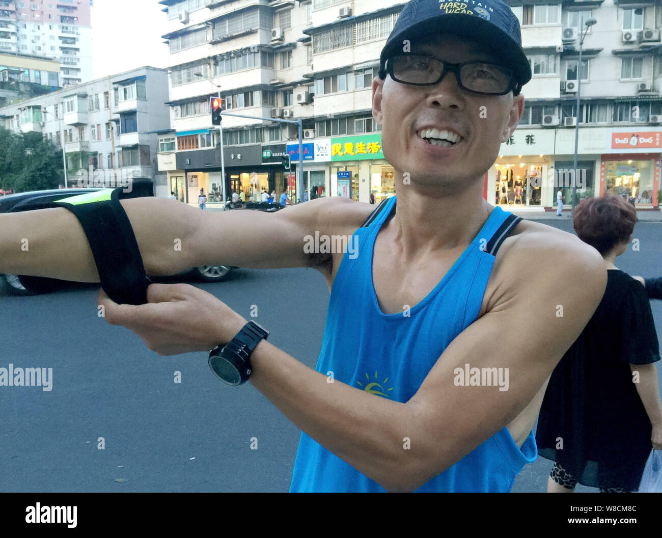 47-year-old Chinese street cleaner Chen Xuejun reacts during a running ...