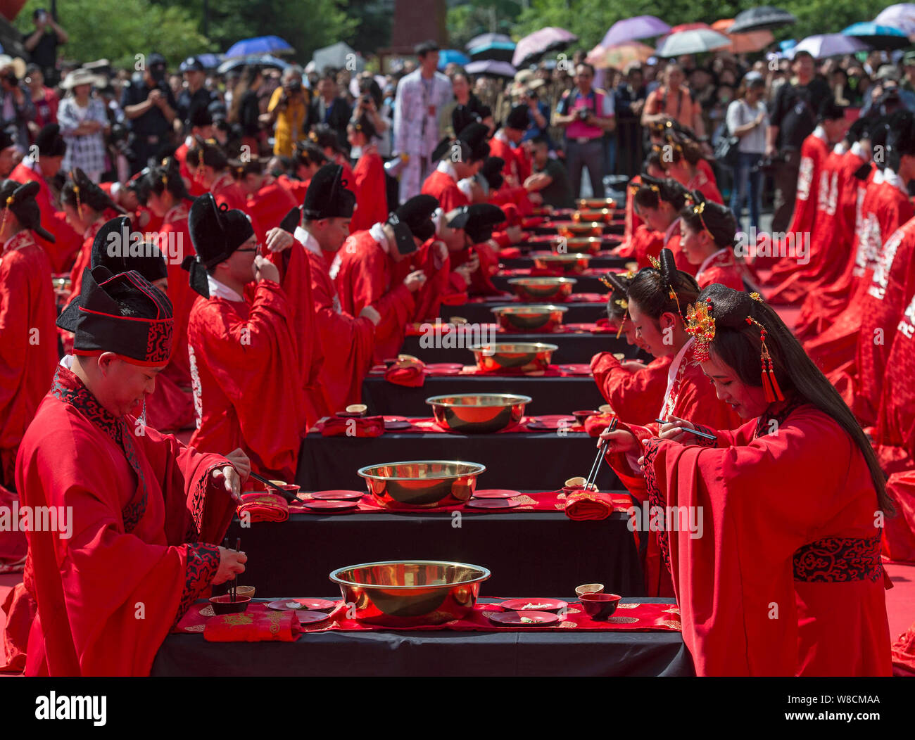 Couples of newlyweds dressed in Chinese Han costumes take part in a Han ...