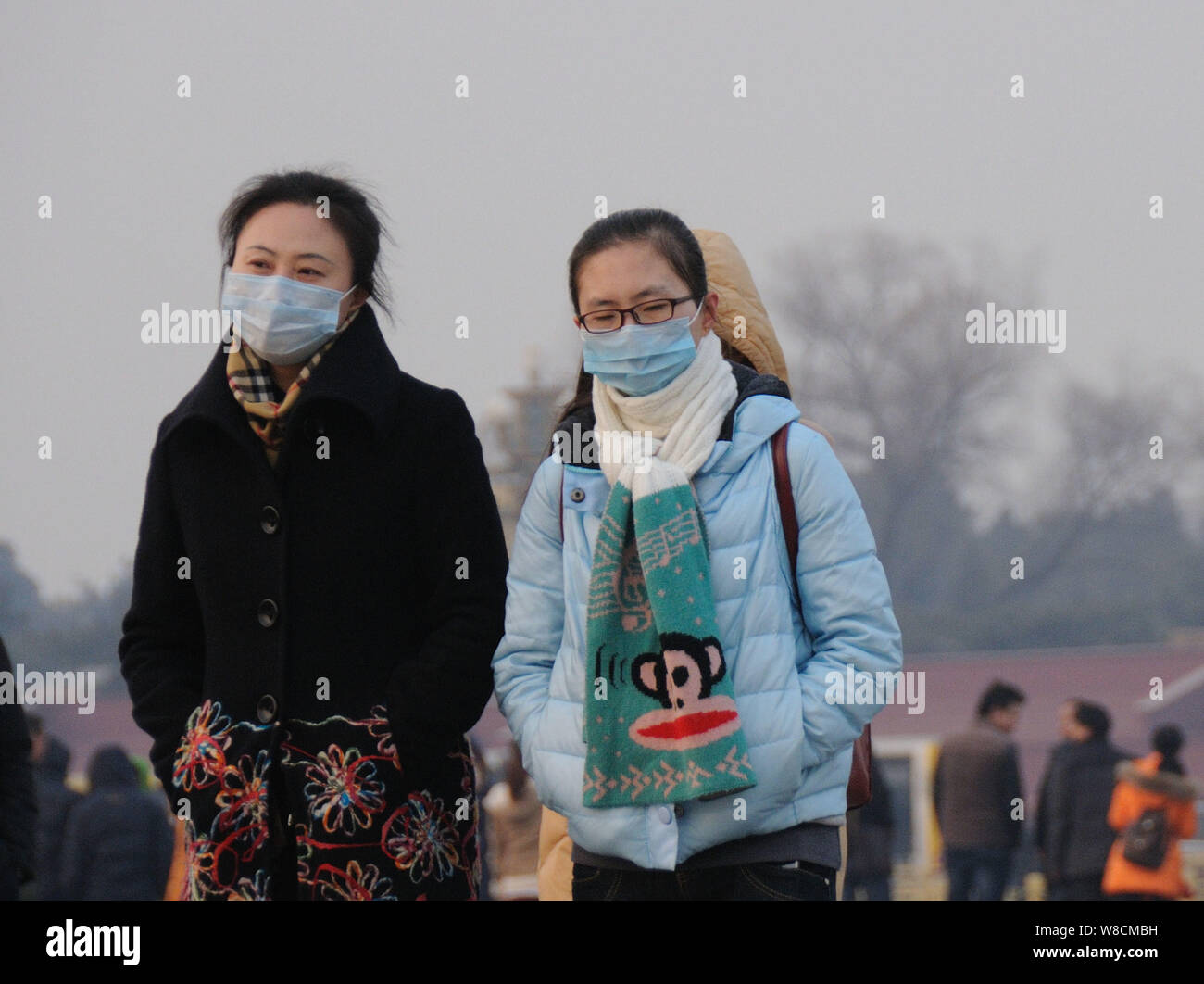 Tourists wearing face masks visit the Tiananmen Square in heavy smog in ...