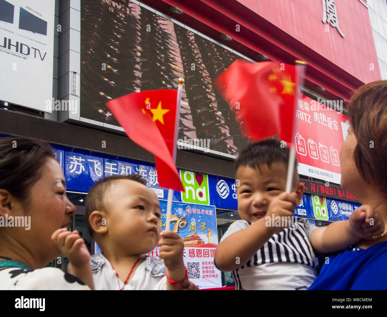 Local Chinese residents watch the live TV broadcast of the military ...