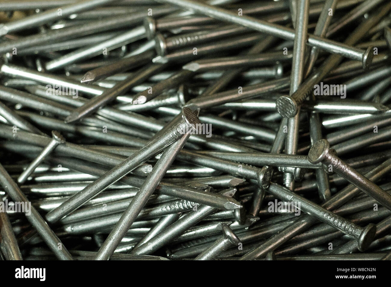 Close-up of shining steel nails piled in the box Stock Photo - Alamy
