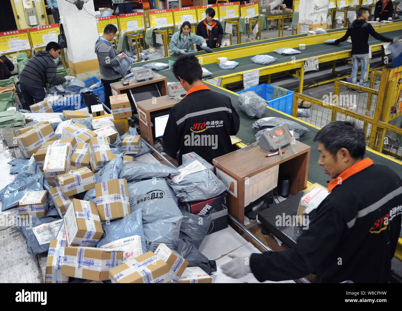 --FILE--Chinese workers sort parcels at a distribution center of STO ...