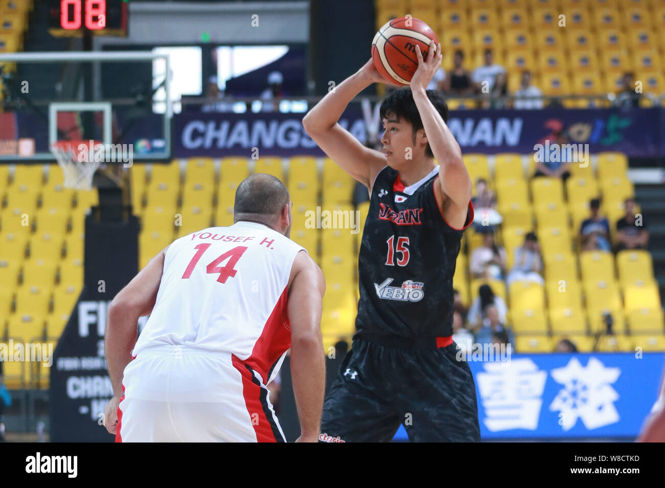 Joji Takeuchi of Japan, right, passes the ball against Hamza Yousef of ...
