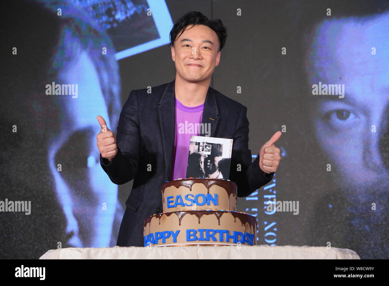 Hong Kong singer Eason Chan poses with a birthday cake at a press ...