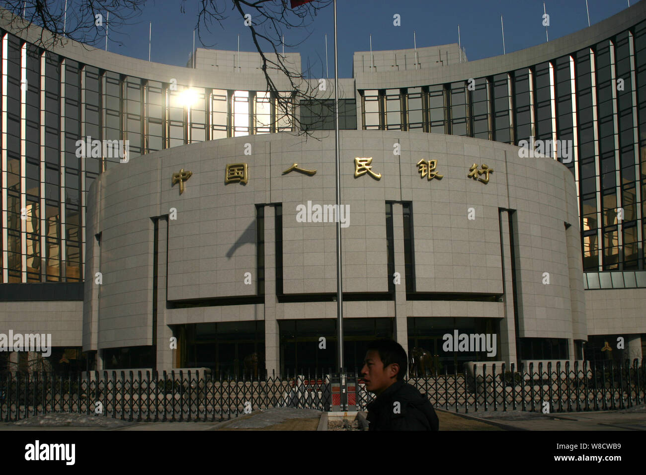 --FILE--A pedestrian walks past the headquarters and head office of the ...