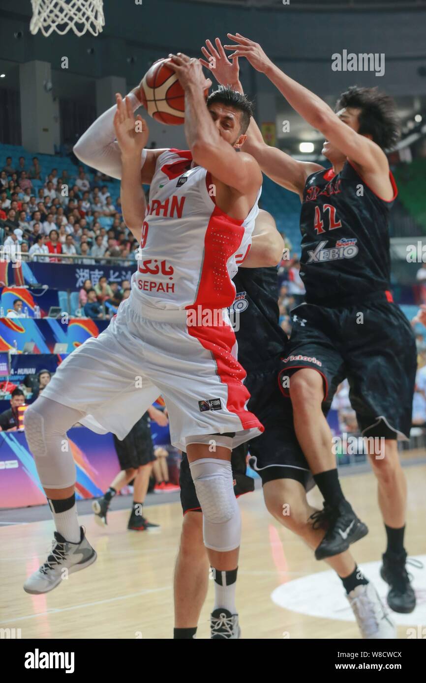 Kenta Hirose of Japan, right, challenges Mohammad Hassanzadeh in a group match during the 2015 ...