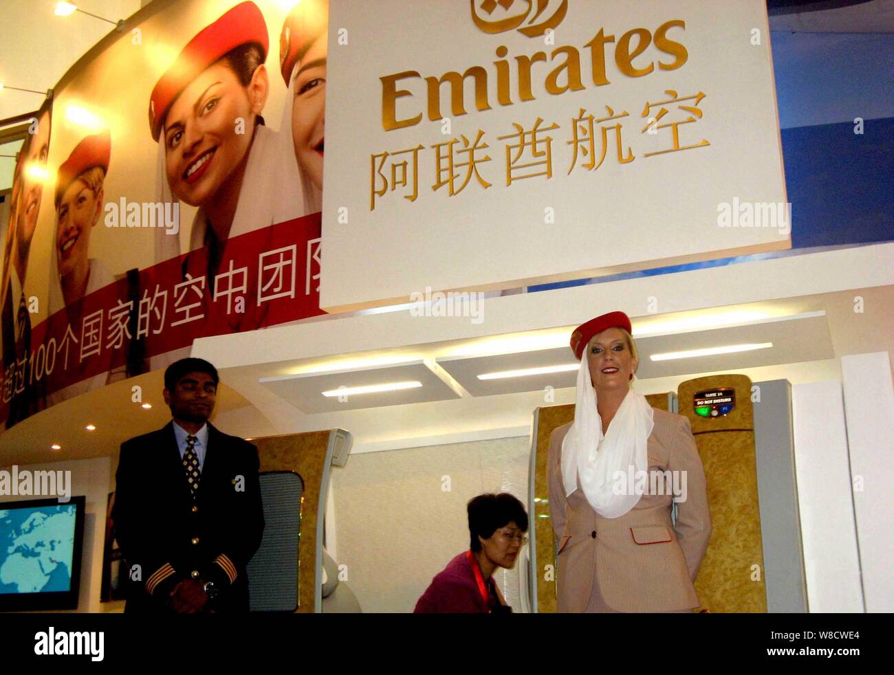 --FILE--Foreign employees pose at the stand of Emirates Airline during ...