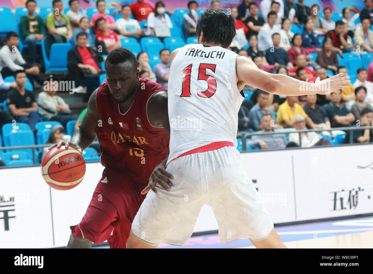 Joji Takeuchi of Japan, right, challenges Mohd Mohamed of Qatar in a ...