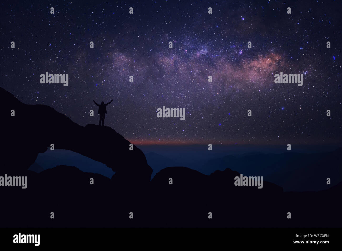 Man who feels on top of the world looking at the milky way Stock Photo ...