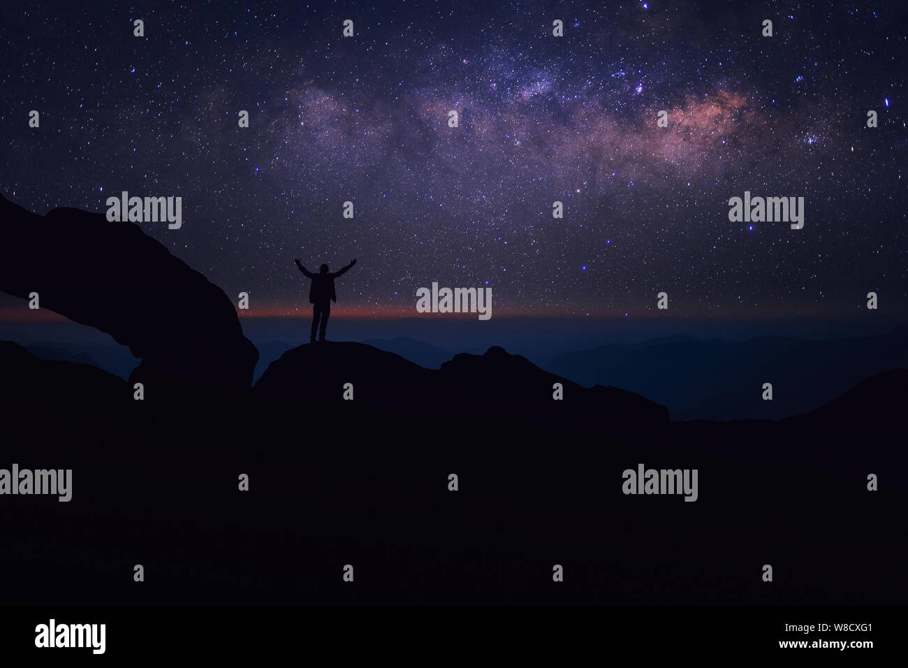 Man who feels on top of the world looking at the milky way Stock Photo ...