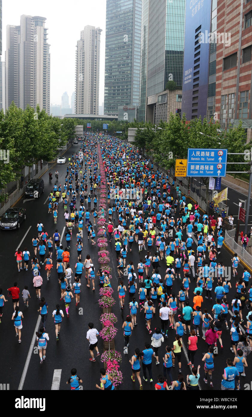 Participants run during the 2015 Shanghai Half Marathon in Pudong ...