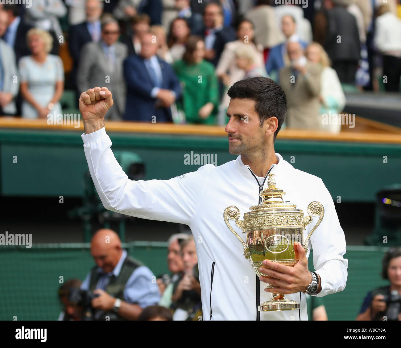 Smiling holding trophy achievement professional sportsperson fist hi ...