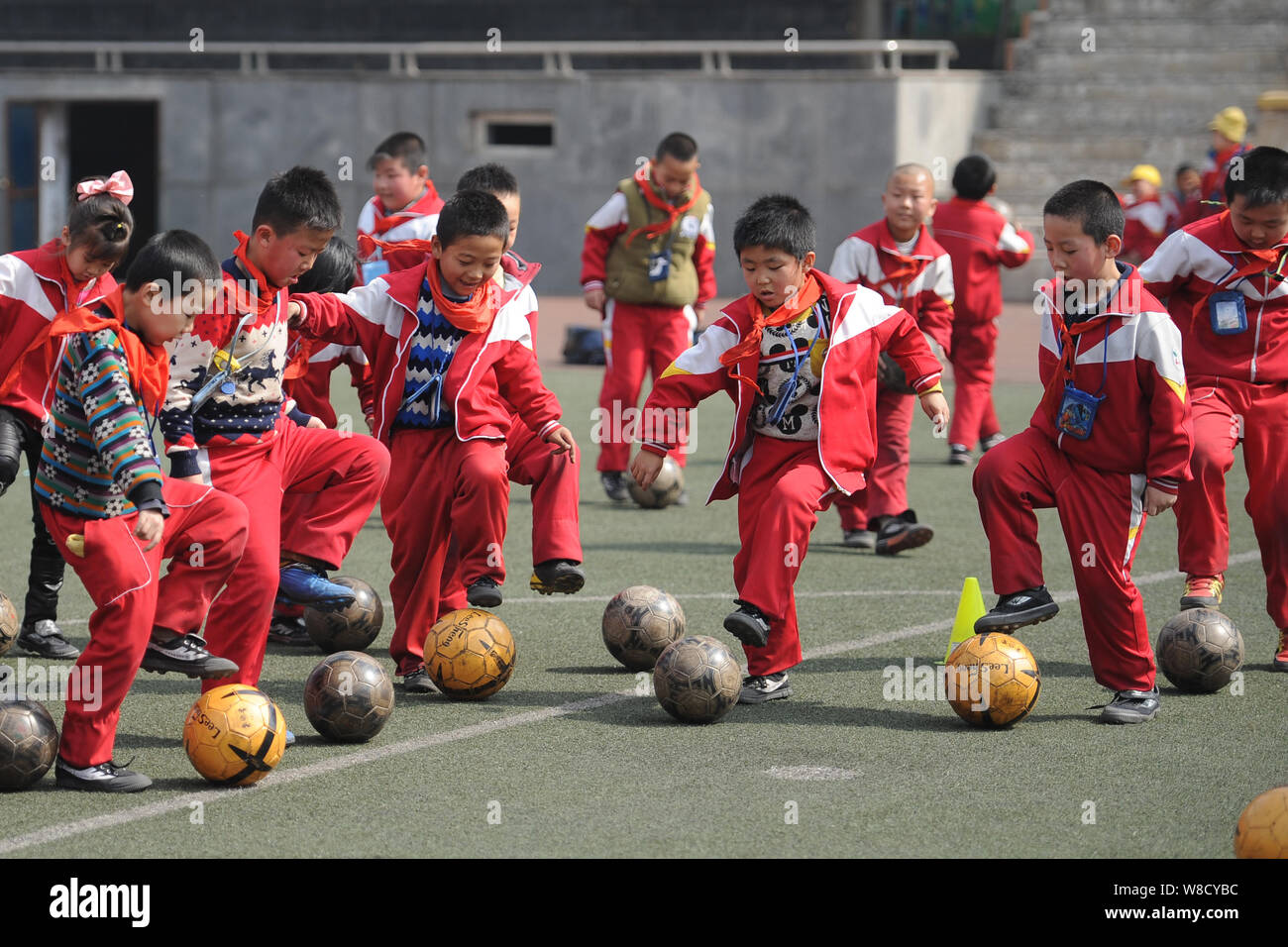 --FILE--Chinese students practise football skills during a training ...