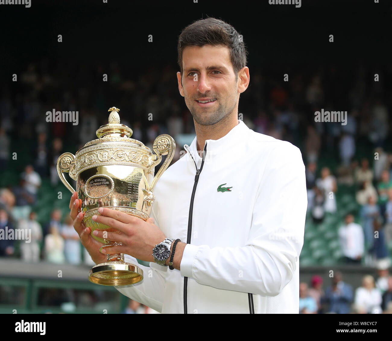 Holding trophy winning smiling standing professional sportsperson ...