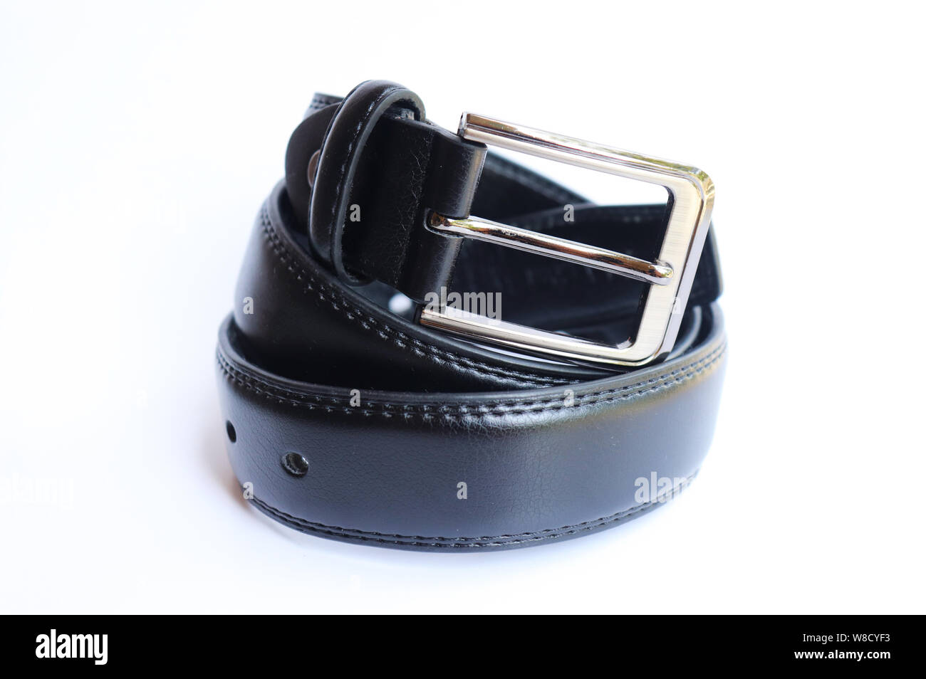 Closeup black leather belt on white background Stock Photo - Alamy