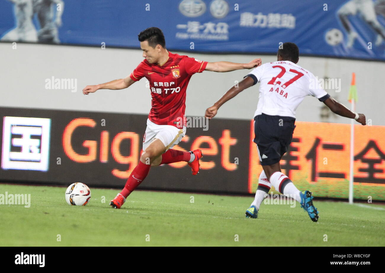Gao Lin of Guangzhou Evergrande, left, challenges David Alaba of Bayern ...