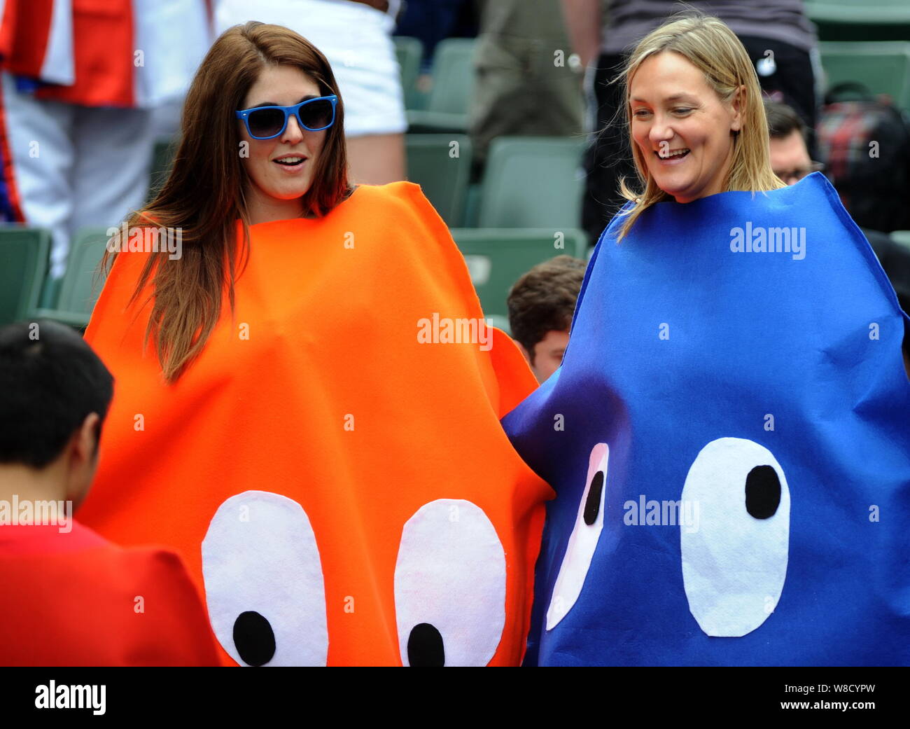 Female fans wearing weird clothing pose for photos during a rugby match ...
