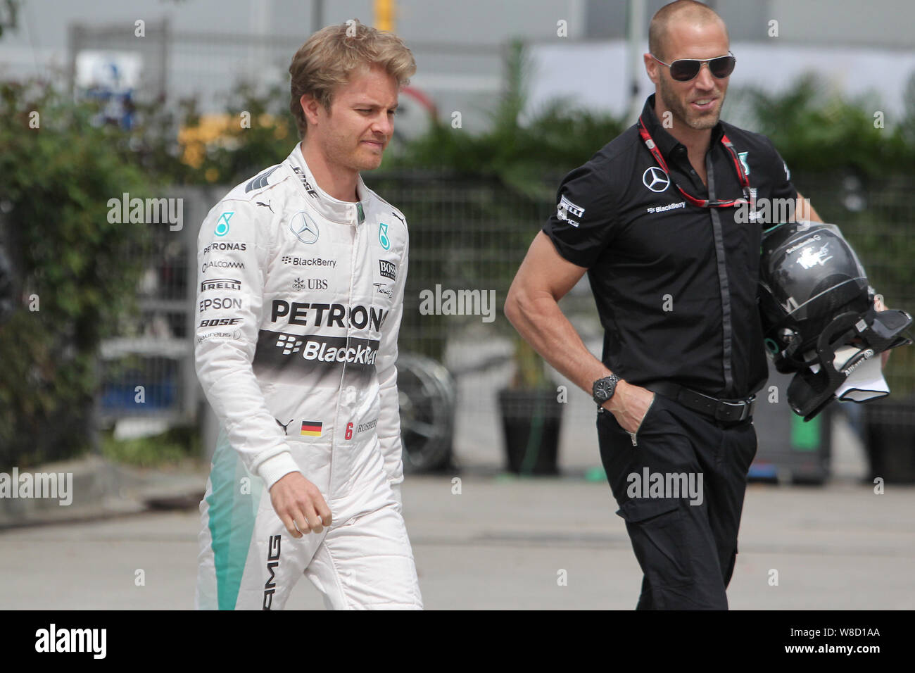 German F1 driver Nico Rosberg of Mercedes, left, arrives at the ...