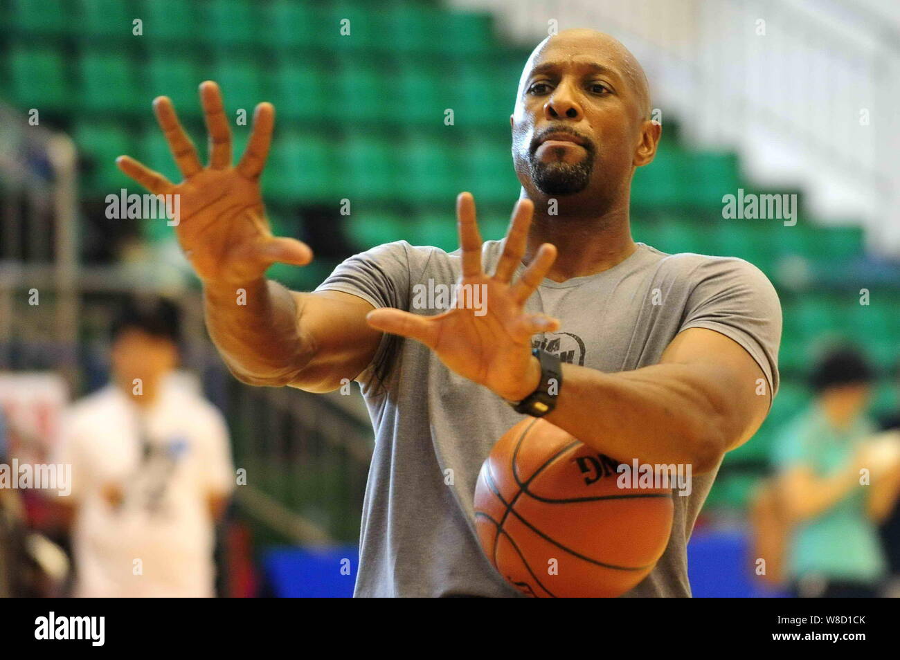 NBA basketball player Alonzo Mourning instructs students to play ...